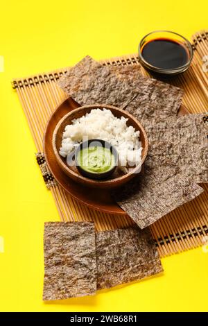 Plate with nori sheets, soy sauce, sesame seeds and vinegar on light ...