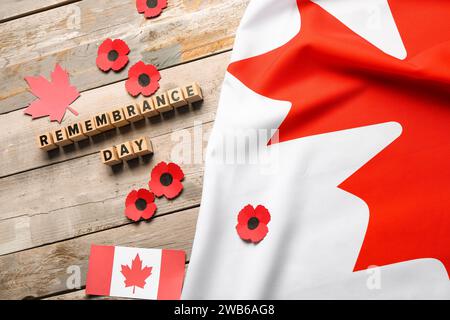 Poppy flowers with flags of Canada and card on grunge pink background ...