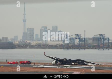 Officials investigate a burnt Japan Airlines Airbus A350 after a ...