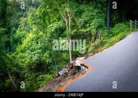 damaged and collapsed part of the concrete road due to flooding and ...