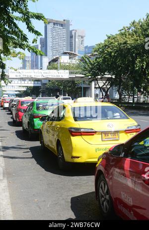 A long line of colorful Thai taxis waiting outside the Chatuchak market ...