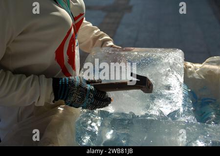 Woman breaking block of ice with an axe, Siem Reap, Cambodia Stock ...
