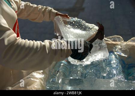 Woman breaking block of ice with an axe, Siem Reap, Cambodia Stock ...