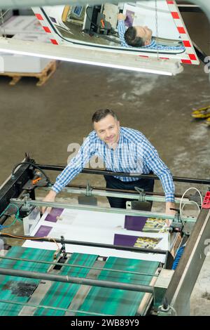 male operator operating industrial printing press Stock Photo - Alamy