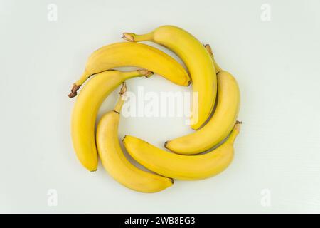 Bananas folded in the shape of a circle lie on white background of the ...