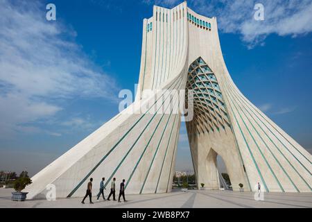 Men walk at the Azadi Tower (Freedom Tower), an iconic landmark in ...