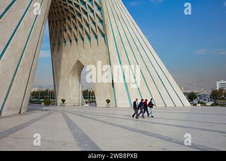 Men walk at the Azadi Tower (Freedom Tower), an iconic landmark in ...