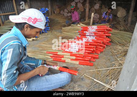 A worker at the local factory makes broom to sell Stock Photo - Alamy