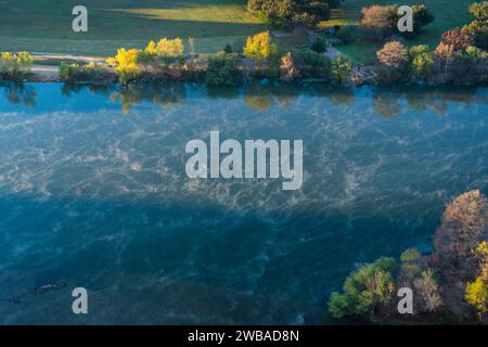 Mist rising on Ladybird Lake with fall foliage along nature trail in ...