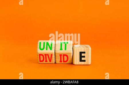 Unite or divide symbol. Concept word Unite or Divide on wooden cubes ...