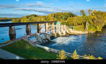 Aerial View of Argo Dam, Rowing Team, and Railway Bridge at Golden Hour ...