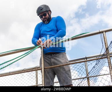 Rappeller carefully checking safety equipment for rappelling. Healthy ...