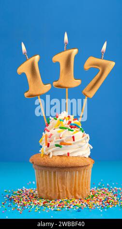 Candle number 117 - Cake birthday in blue background Stock Photo - Alamy
