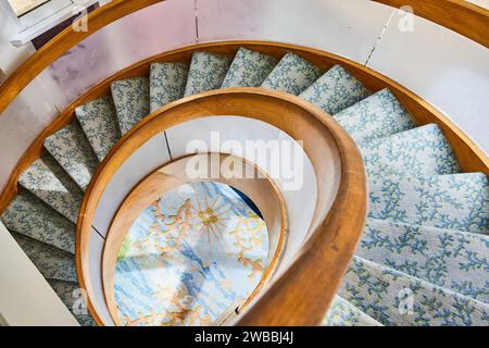 Top-down view of a spiral wooden staircase with handrail inside Schloss ...