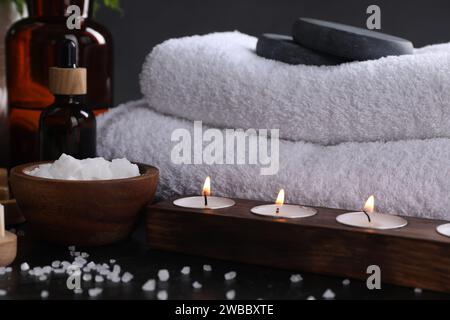 Many burning candles and sea salt on tray Stock Photo - Alamy