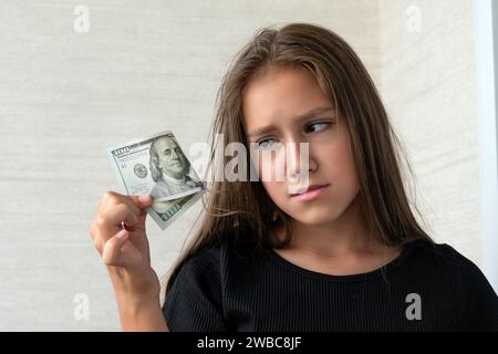 Sad child with money dollar. Not enough money. white background Stock ...