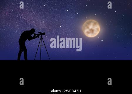 Astronomer looking at moon and stars through telescope outdoors Stock ...