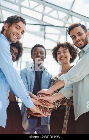 group of young successful people stands around hands together Stock ...