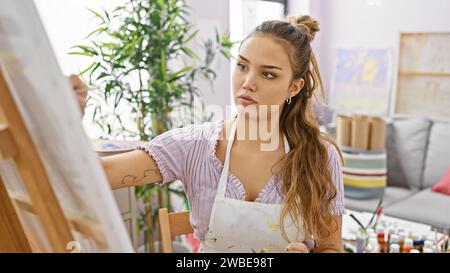 Young hispanic woman artist drawing on touchpad at art studio Stock ...