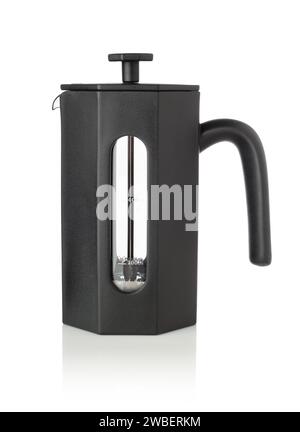 A glass French press of tea and a small glass of tea on a white table ...