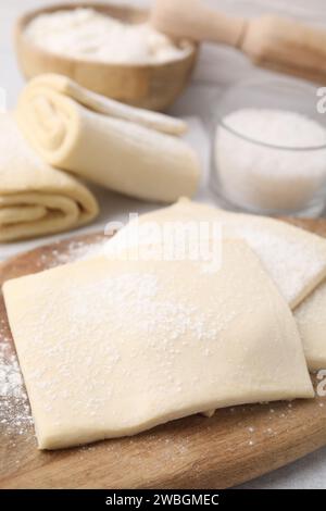 Raw puff pastry dough on wooden table, closeup Stock Photo - Alamy