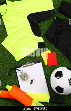 Referee equipment. Whistle, clipboard, cards and stopwatch on black ...