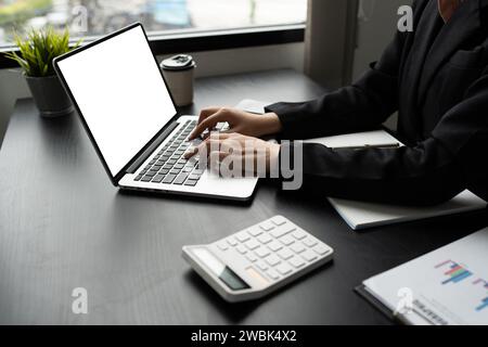 Female accountant using calculator and keyboard for budgeting and ...
