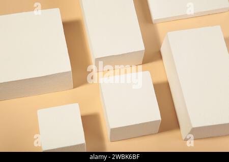 Pyramid of beige cubes on top with single red one on table Stock Photo ...
