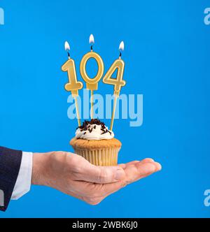 Golden number 104 birthday candle on white background Stock Photo - Alamy