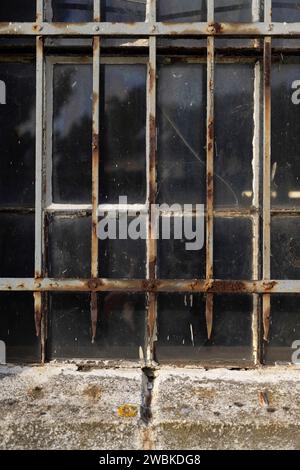 Broken Glass Window With Rusted Metal Grate Stock Photo - Alamy