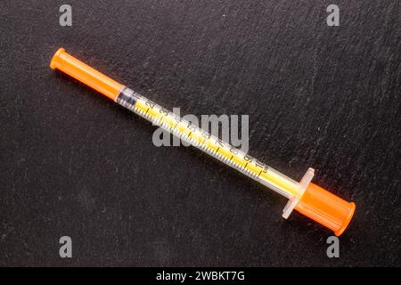 One medical syringe on slate stone, macro, top view Stock Photo - Alamy