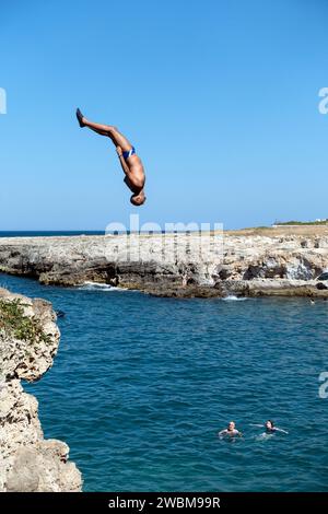 A man dives into the Mediterranean sea from the walls of Fort Saint ...
