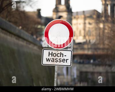Hochwasser (floods) sign at a barrier. The street is closed because of ...