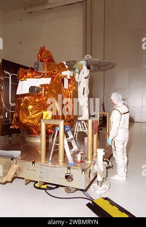 Workers in the Space Assembly and Encapsulation Building 2 prepare the ...