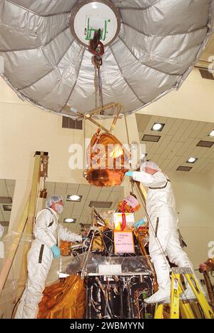 Technicians guide The Gamma Ray Spectrometer (GRS)into place to be ...