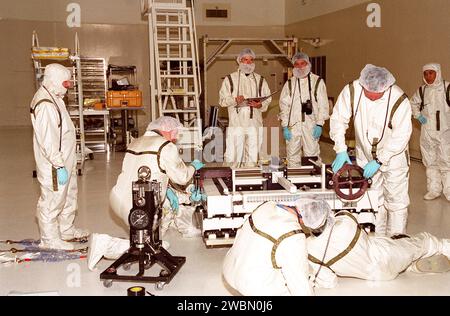 Workers in the Space Assembly and Encapsulation Building 2 prepare the ...