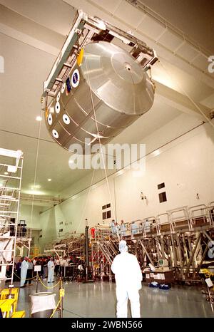 KENNEDY SPACE CENTER, FLA. - Suspended from an overhead crane in the ...