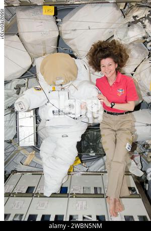 Expedition 27 Flight Engineer Cady Coleman is carried in a chair to the ...