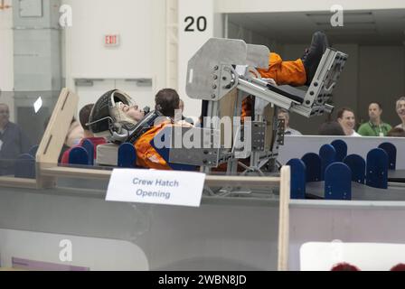 Jennifer Peterson demonstrates the Orion crew exploration vehicle mock ...
