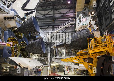 KENNEDY SPACE CENTER, FLA. - A forklift lowers one of two containers ...