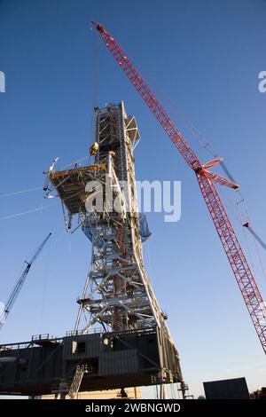 Cranes at Kennedy Space Center lift payload canister #1 from a ...