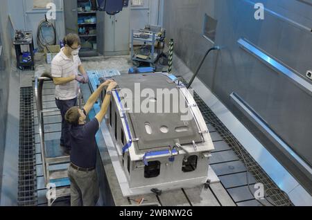 Technicians work on the composite crew module adapter (CMA) panels for ...