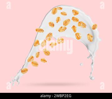 Rolled oats and milk splash on light blue background Stock Photo - Alamy