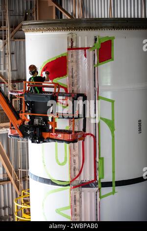 A worker with NASA’s Exploration Ground Systems (EGS) finishes the ...