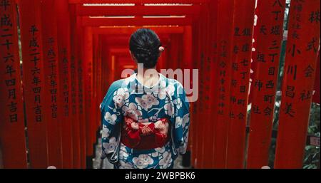 Woman, shinto religion and walk by gates in japan, spiritual path and ...