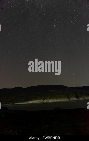 A night sky filled with a myriad of twinkling stars and scattered ...