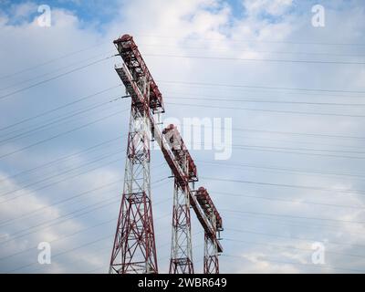 Three masts of a high-voltage power line against the background of the ...