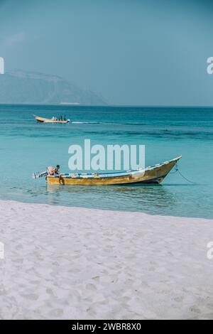 Yemen, Middle East: a boat and the cliffs of Ras Shuab, Shuab Bay beach ...