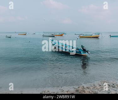 Yemen, Middle East: a boat and the cliffs of Ras Shuab, Shuab Bay beach ...