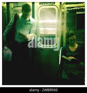 People reading books on subway Stock Photo - Alamy